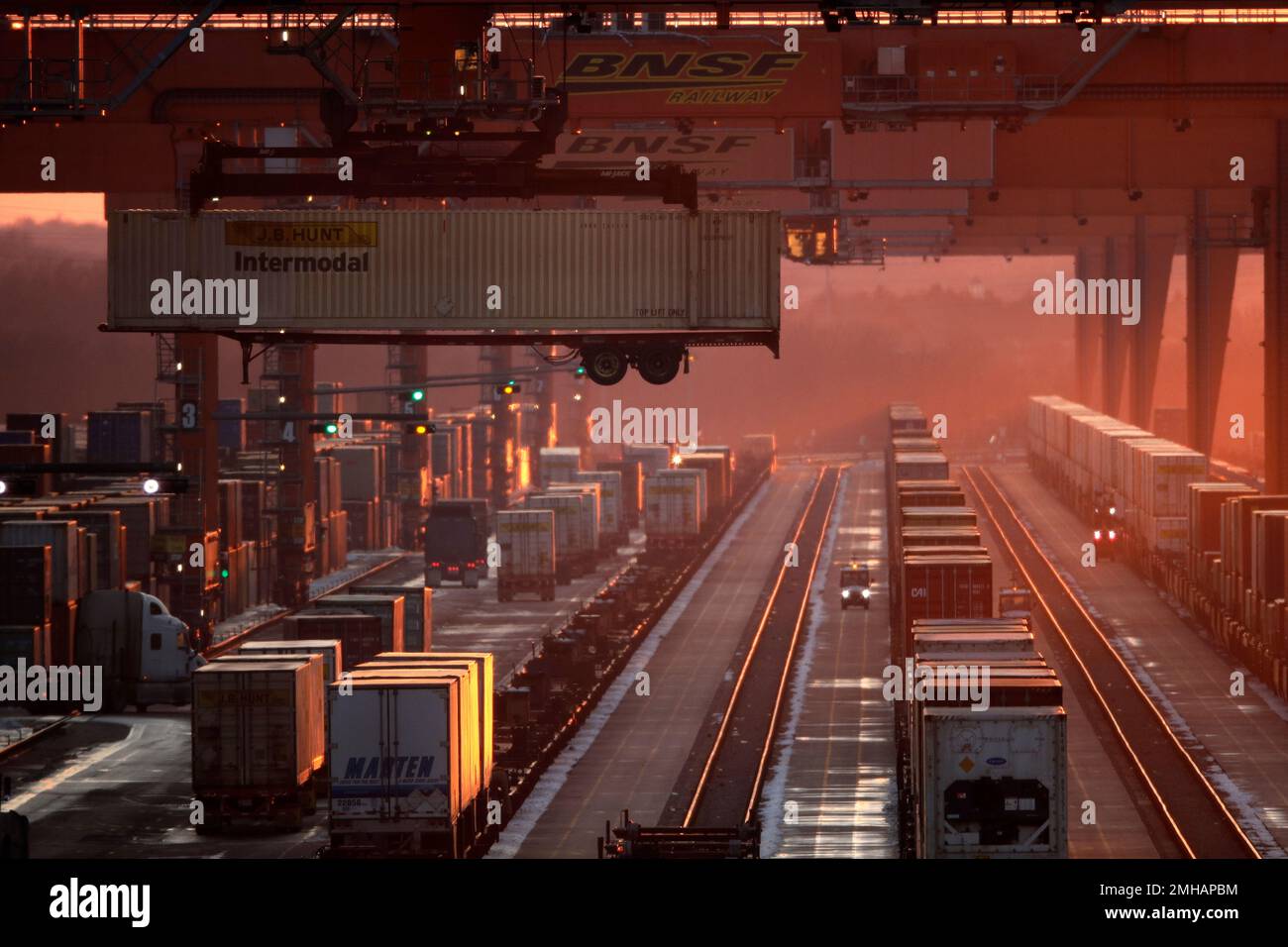 Shipping containers are offloaded at an a BNSF Railway intermodal ...