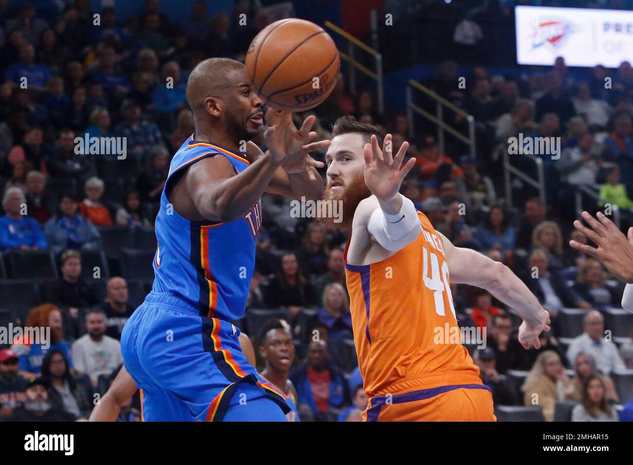 Oklahoma City Thunder guard Chris Paul, left, passes the ball next to ...