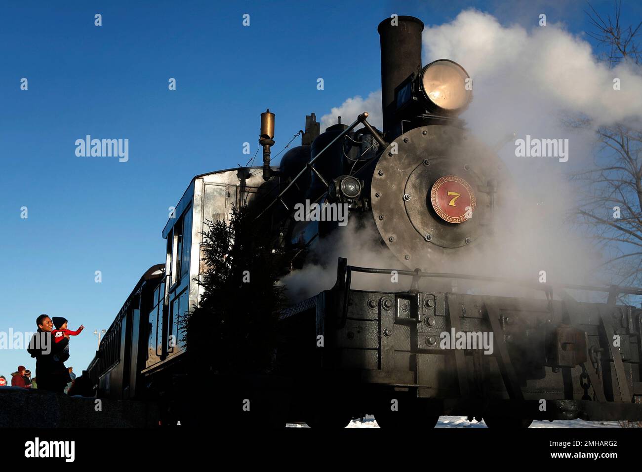Passengers check out the steam locomotive prior to boarding The Polar ...
