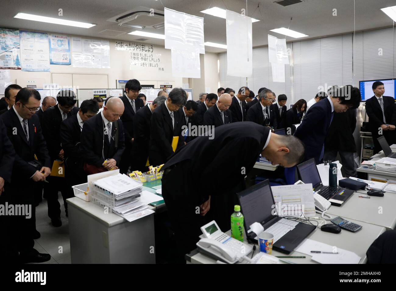 Nihon Kotsu taxi drivers bow to a Shinto shrine during a roll call ...