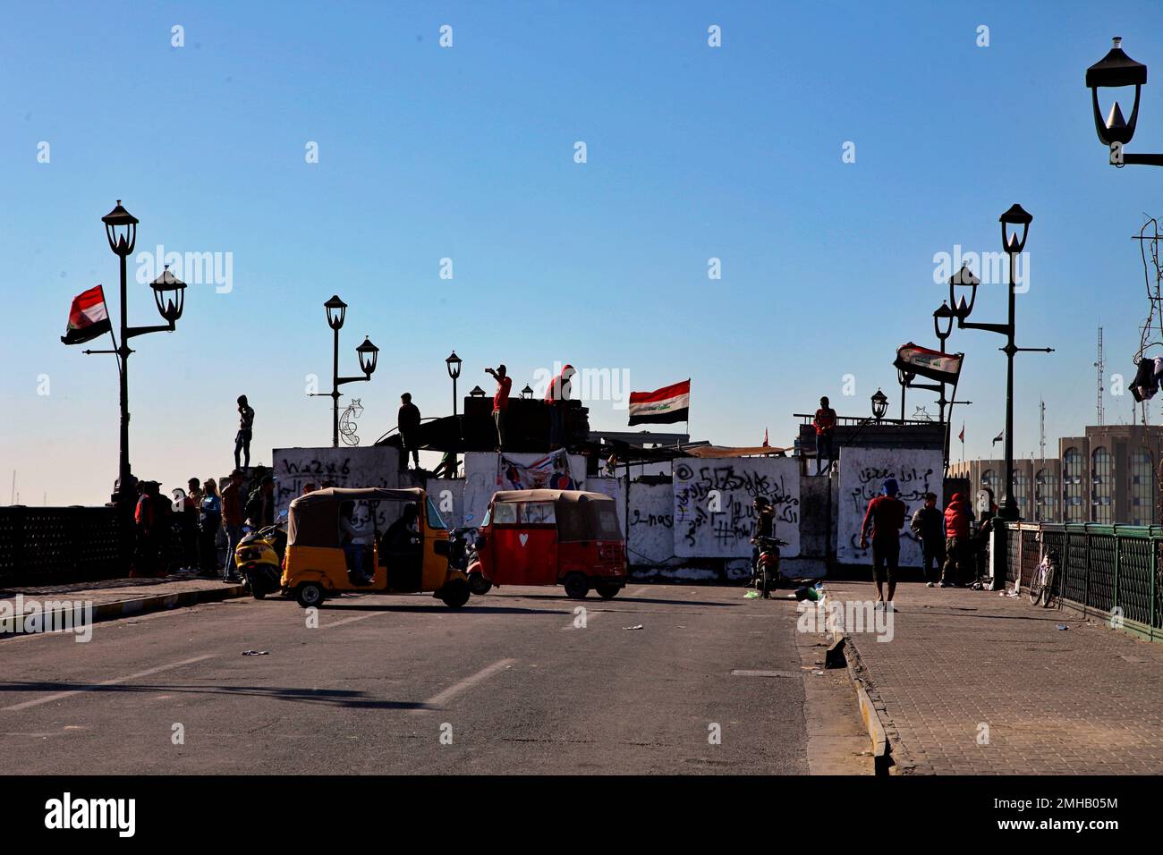 Protesters stage a sit-in on barriers at the Ahrar bridge during anti ...