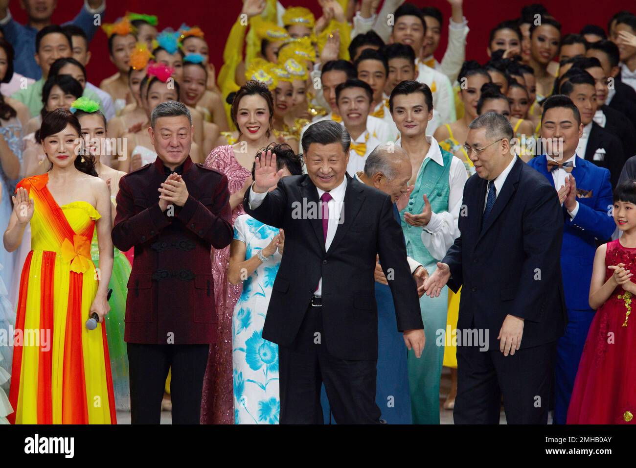 Chinese President Xi Jinping, center, waves during a cultural ...