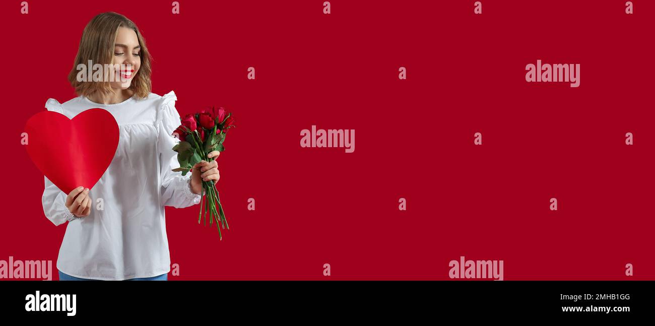 Beautiful young woman holding paper heart and flowers on red background ...