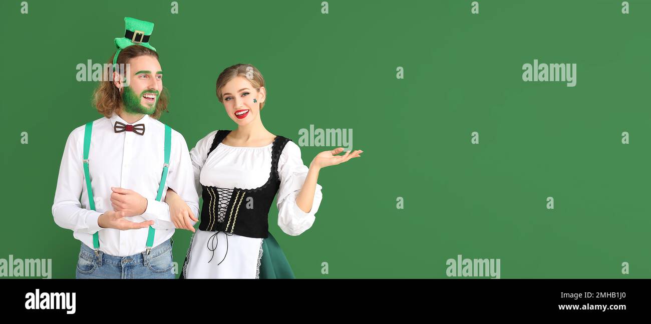 Young couple on green background with space for text. St. Patrick's Day ...