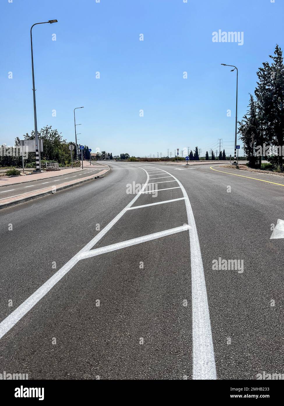 Road with traffic island in city Stock Photo - Alamy