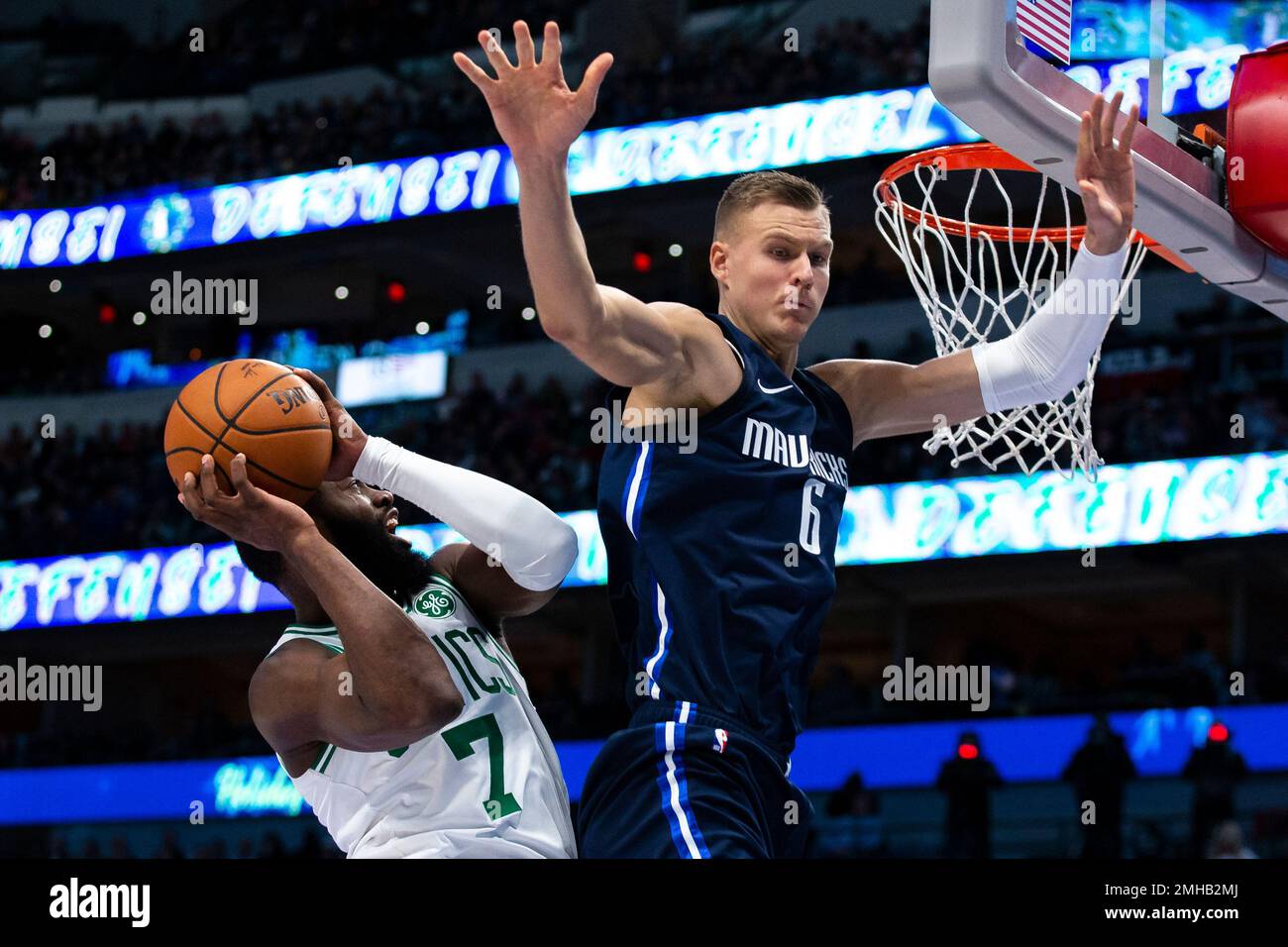 Boston Celtics guard Jaylen Brown (7) shoots as Dallas Mavericks forward Kristaps Porzingis (6 ...