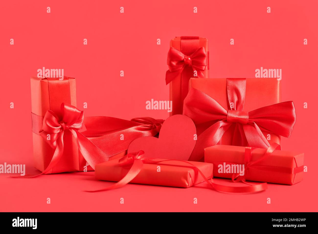 Different gift boxes on red background. Valentine's Day celebration ...
