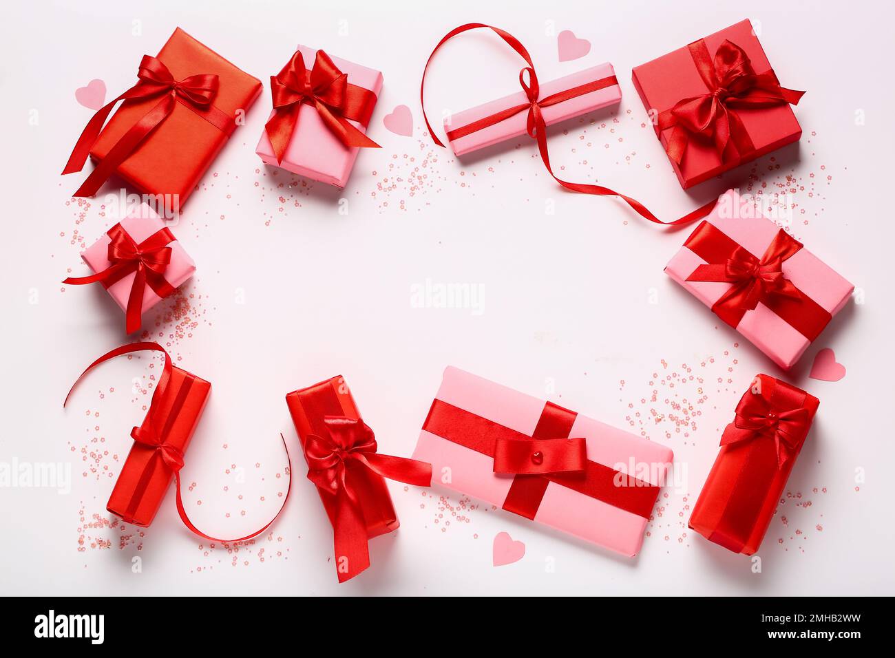 Frame made of beautiful gifts and sequins on white background ...