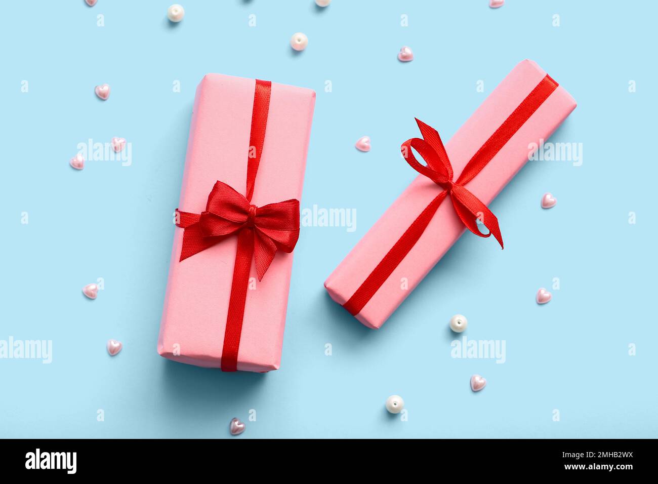 Gifts for Valentine's Day celebration and beads on color background ...