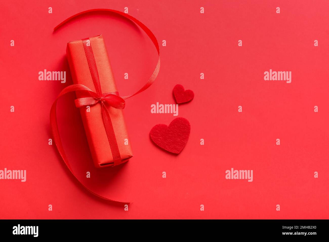 Gift box and decor on red background. Valentine's Day celebration Stock ...