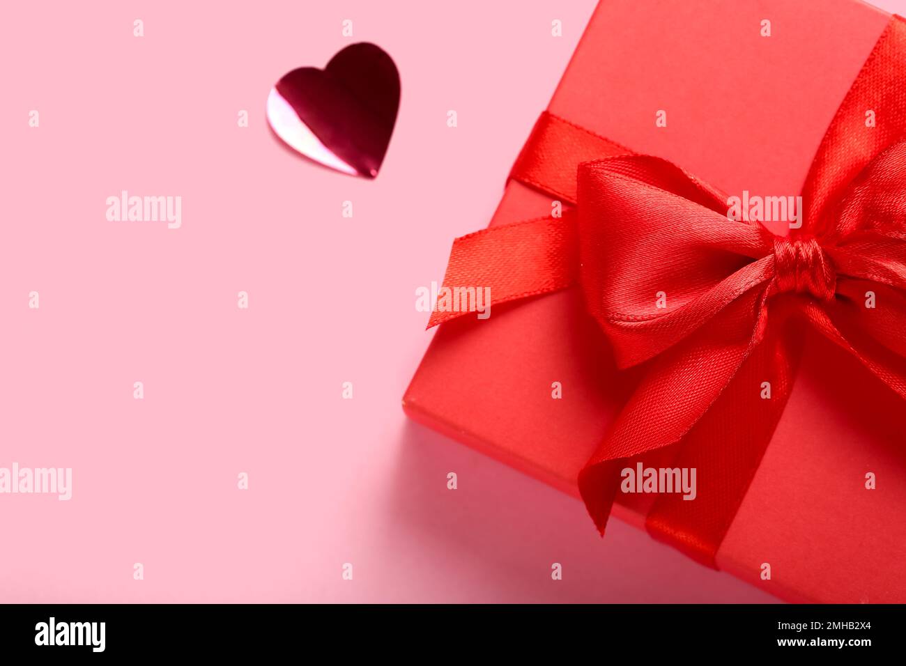 Gift box with beautiful bow on pink background. Valentine's Day ...
