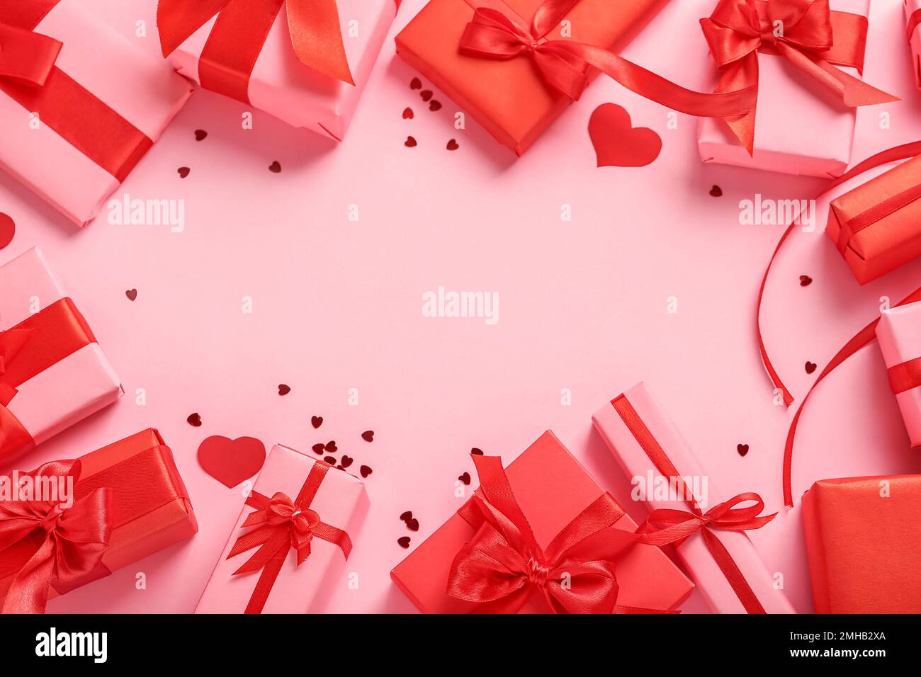 Frame made of gifts for Valentine's Day celebration on pink background ...