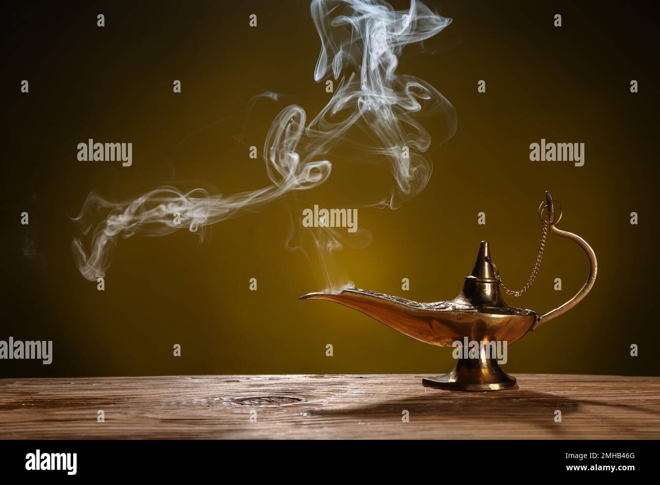 Aladdin lamp of wishes with smoke for Ramadan on table against dark ...