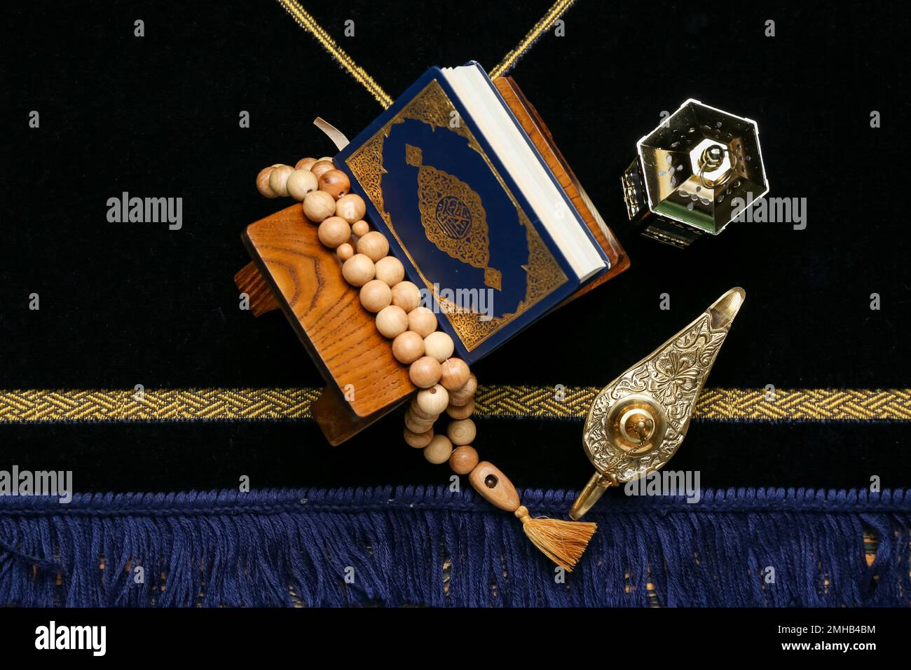 Aladdin lamp, Muslim lantern, Koran and prayer beads for Ramadan on mat ...