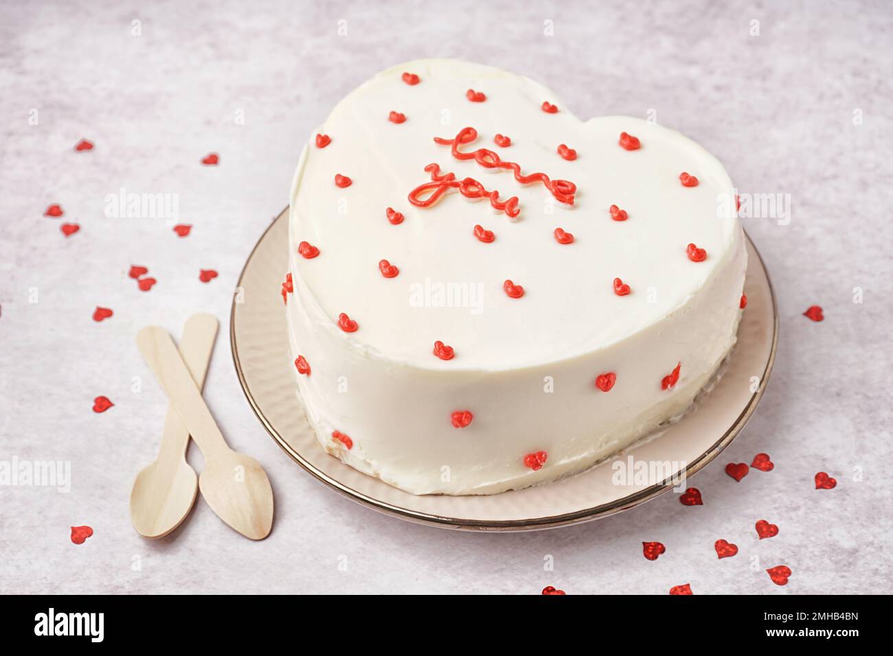 Plate with heart-shaped bento cake on white background. Valentine's Day ...