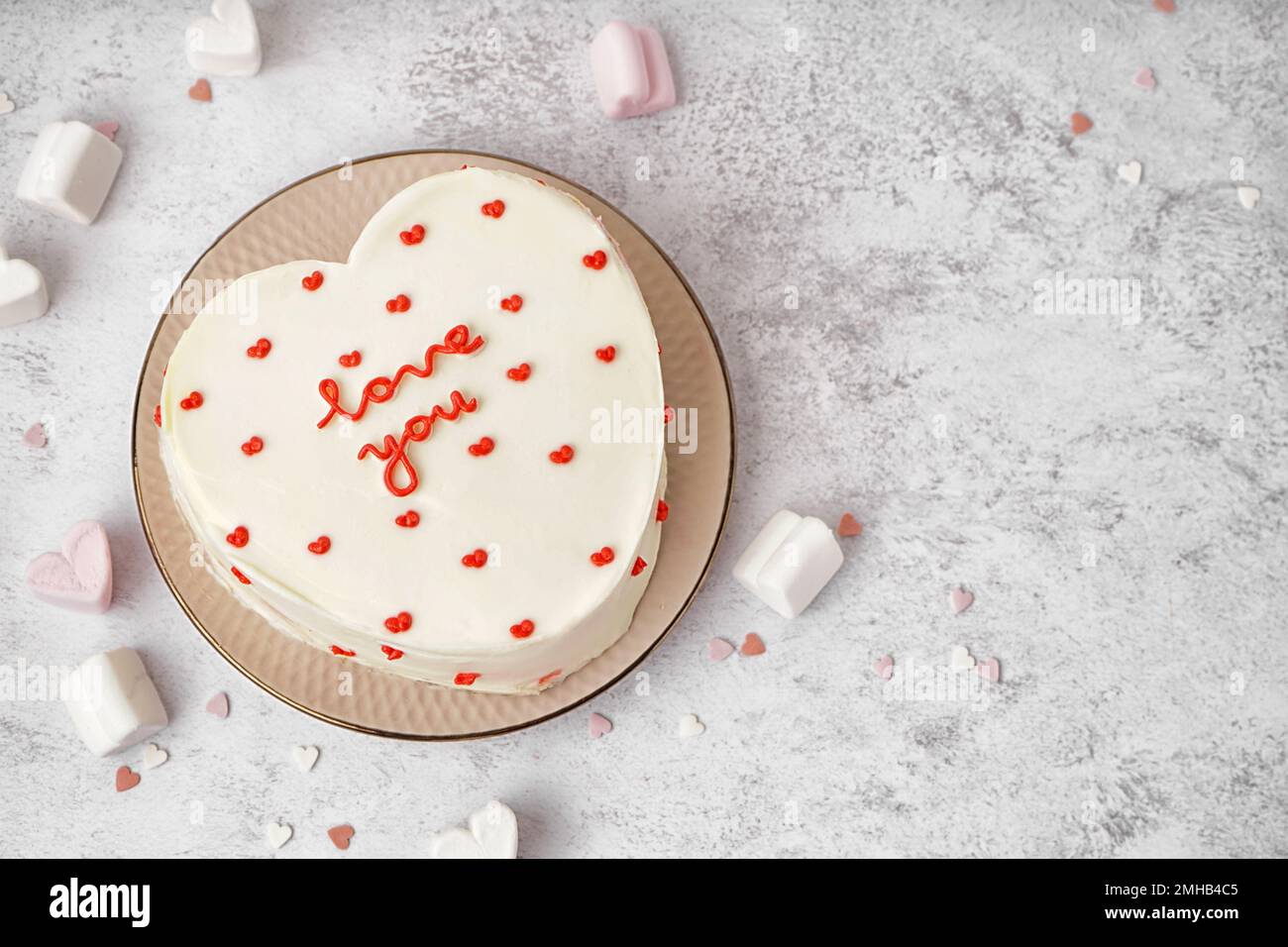 Plate with heart-shaped bento cake on white background. Valentine's Day ...