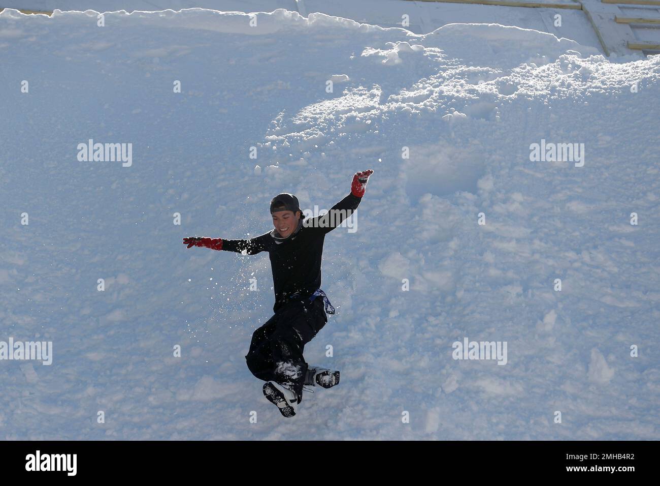 Crews work to construct and cover a giant ski slope with snow on the ...
