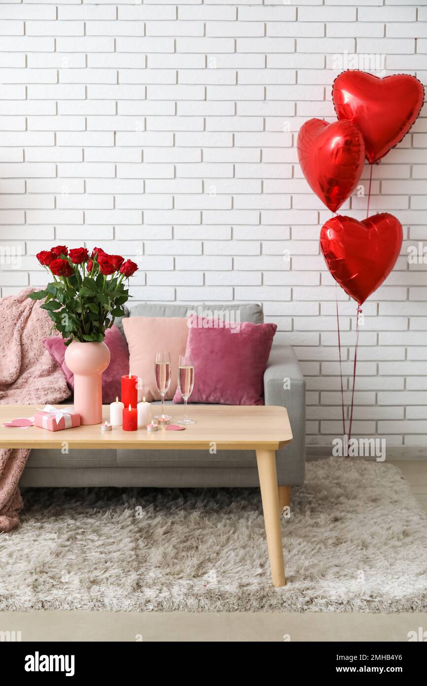 Burning candles, vase with roses, champagne and gift for Valentine's ...