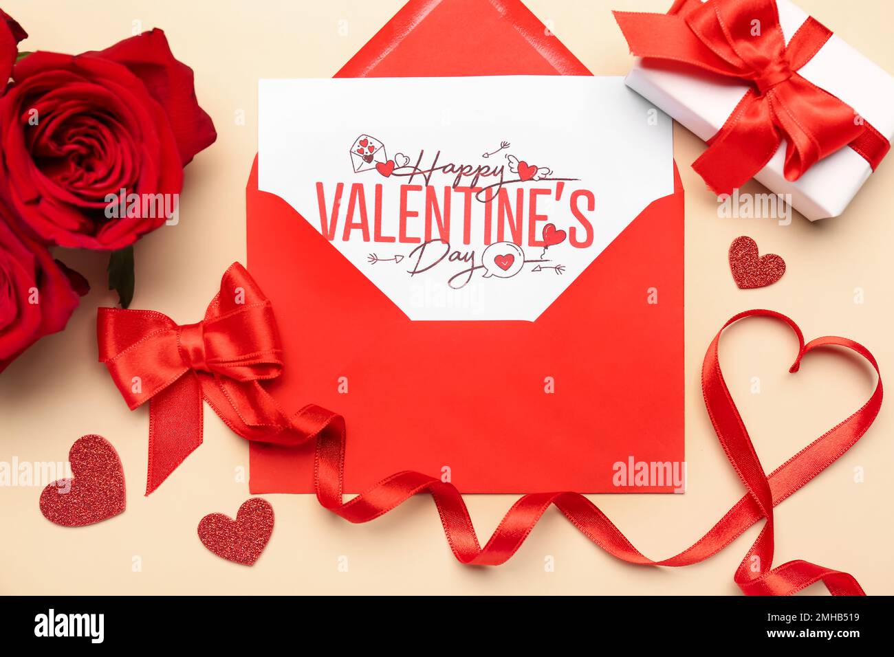 Composition with greeting card in envelope, rose flowers and heart made ...