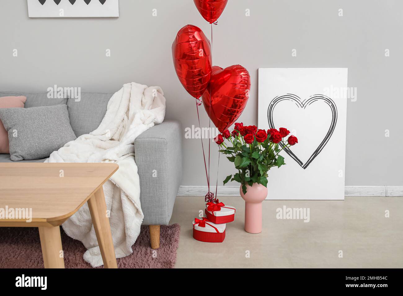 Vase with roses, gifts and balloons for Valentine's Day in interior of ...