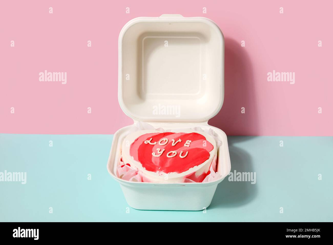 Lunch box with heart-shaped bento cake for Valentine's Day on table ...