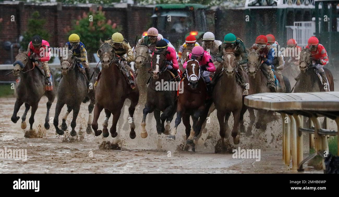 Luis Saez rides Maximum Security, second from right, to the finish line ...