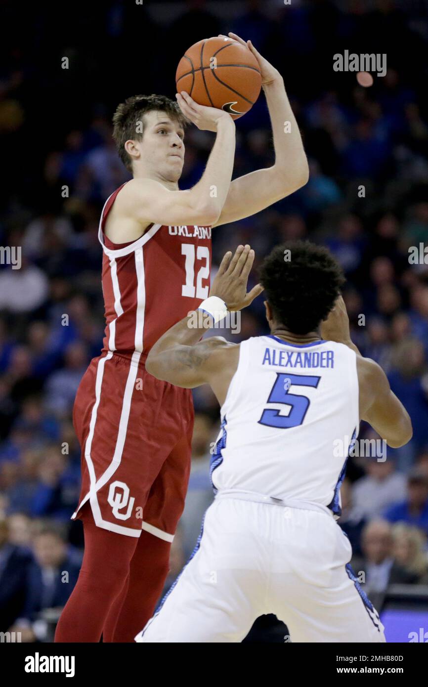 Oklahoma's Austin Reaves (12) shoots over Creighton's Ty-Shon Alexander ...