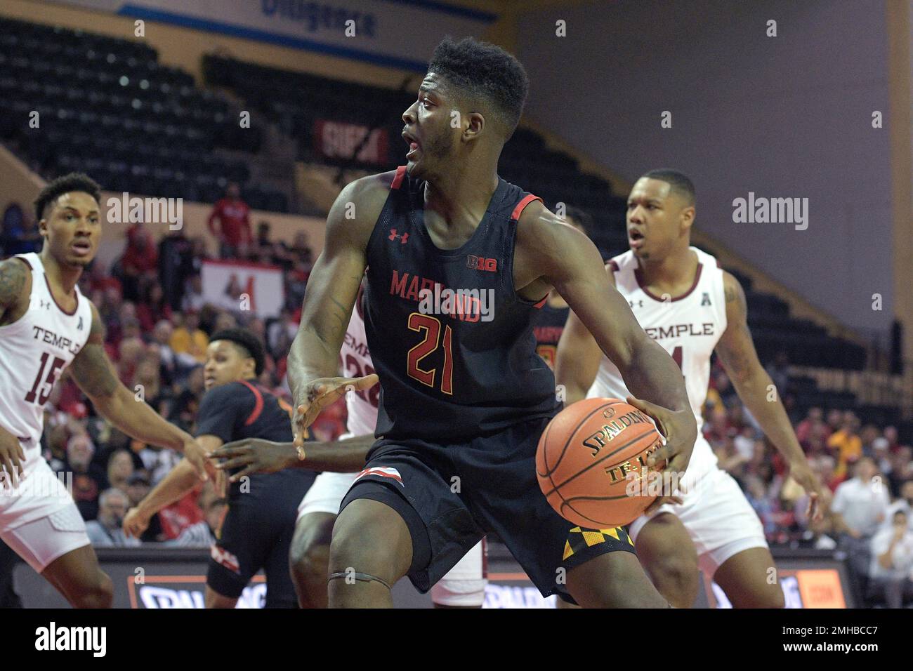 Maryland forward Makhi Mitchell (21) drives to the basket in front of ...