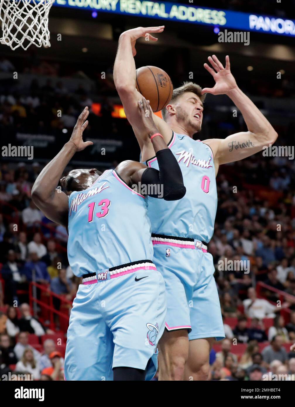 Miami Heat center Bam Adebayo (13) and forward Meyers Leonard (0) go ... Miami Heat center Bam Adebayo (13) and forward Meyers Leonard (0) go ...