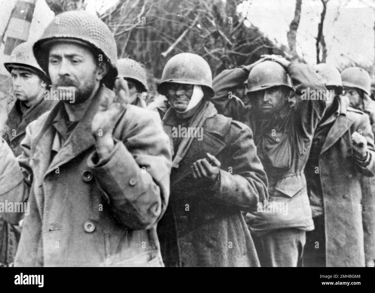 American prisoners of war wait to be marched off to rear positioned POW ...