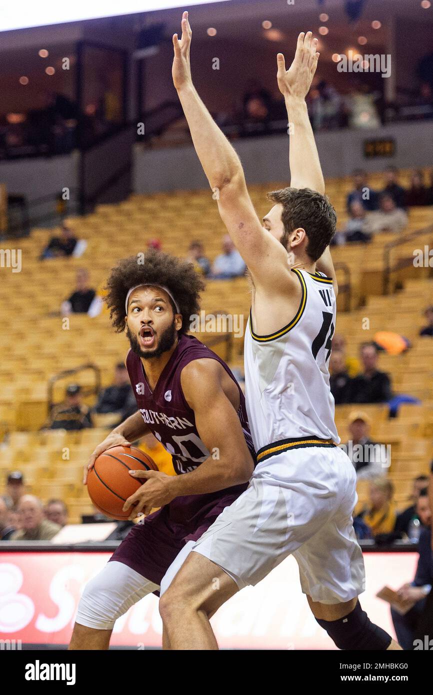 Southern Illinois' Barret Benson, left, shoots around Missouri's Reed ...