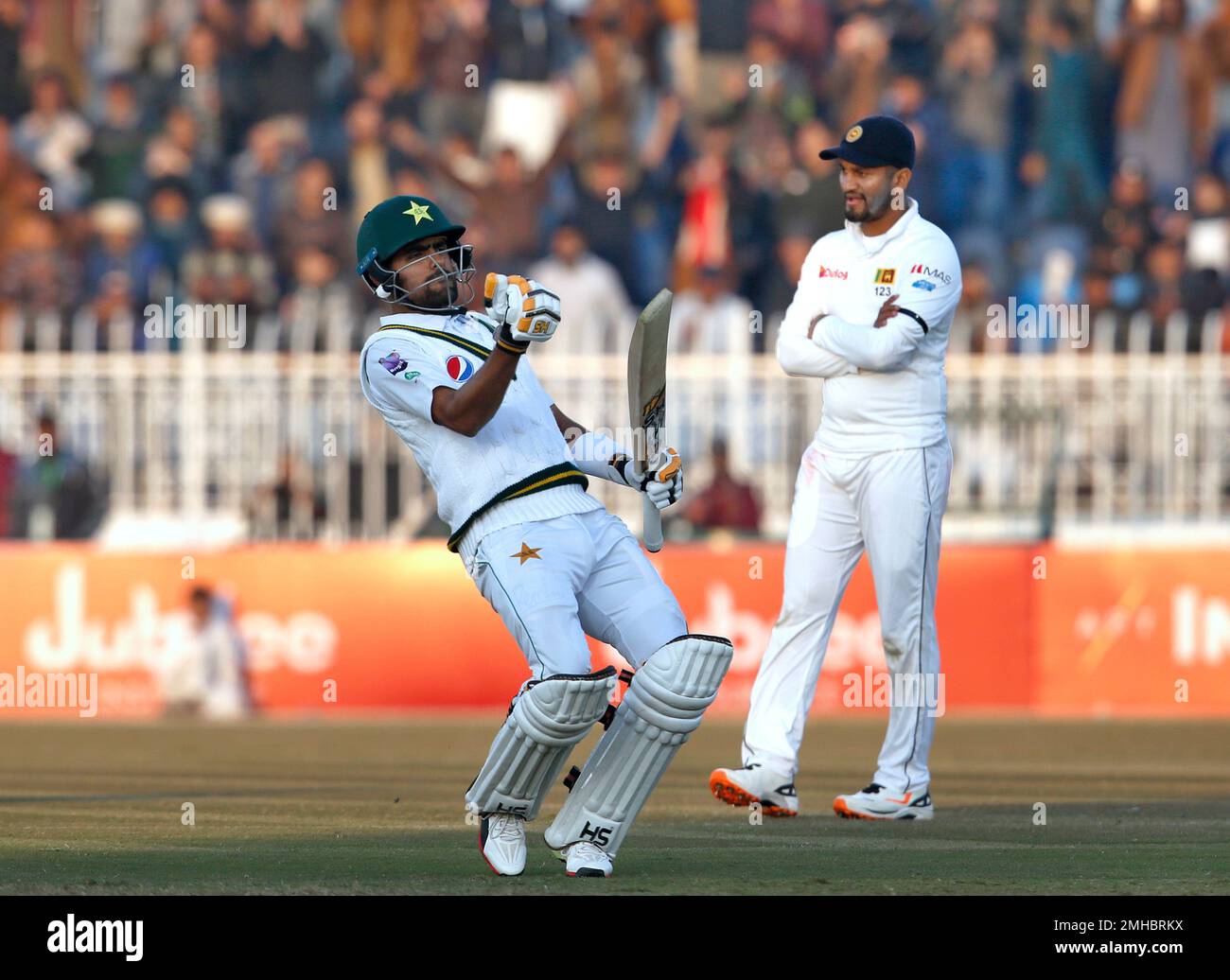 Pakistani batman Babar Azam, left, celebrates after completing his ...