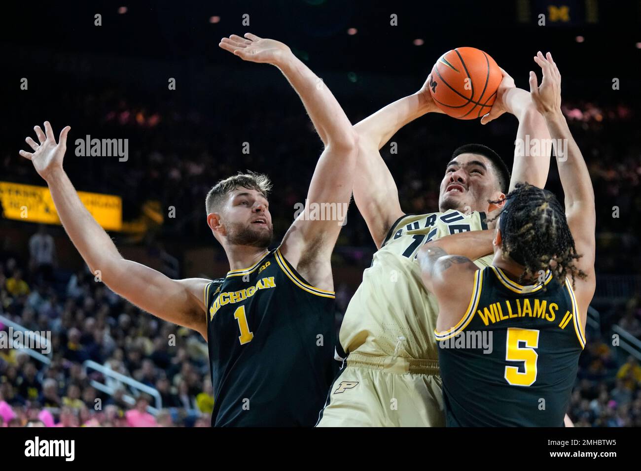 Purdue center Zach Edey, center, shoots between Michigan center Hunter ...