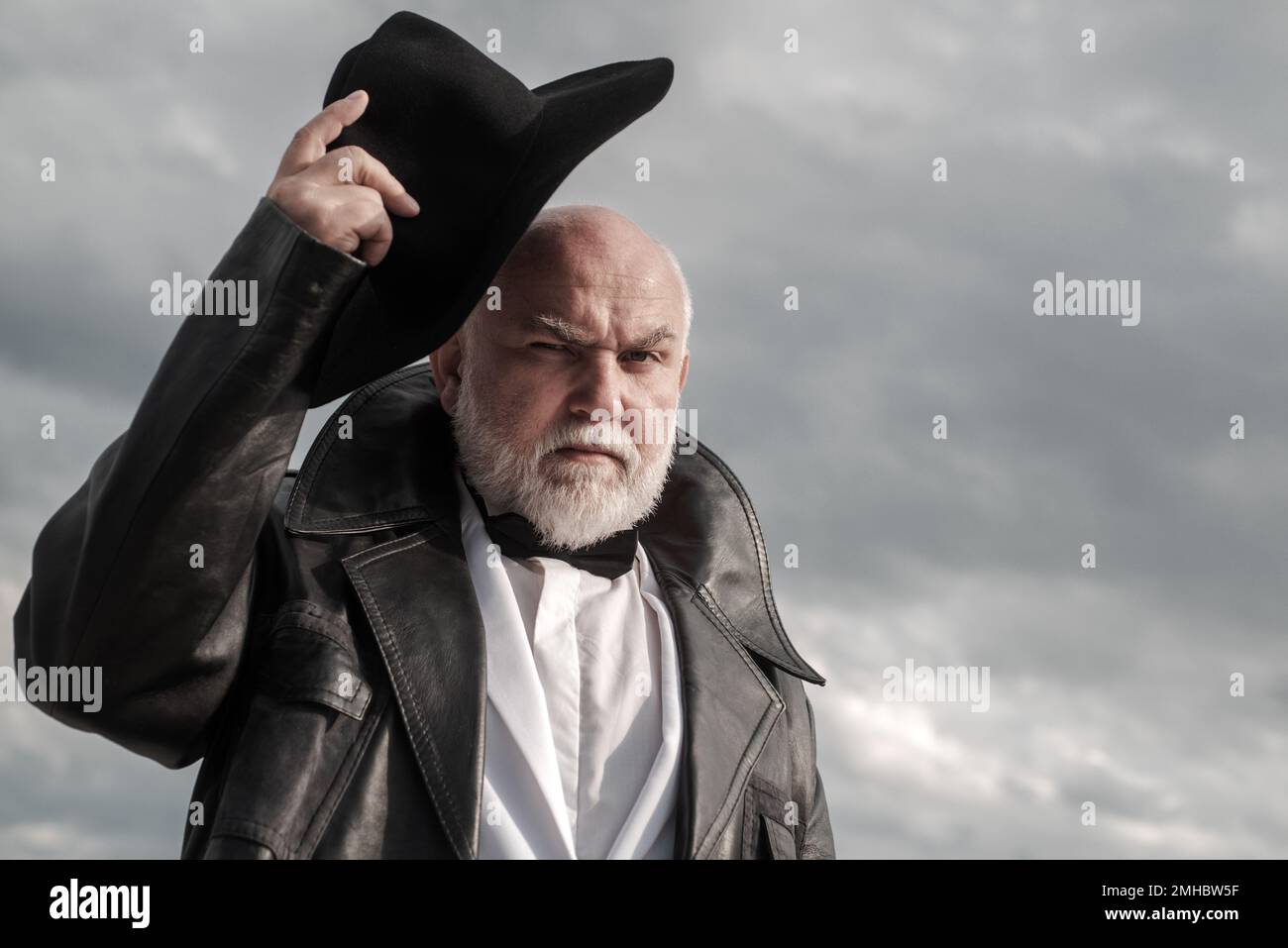 Gangster style. Fashion man in leather coat and hat outdoor. Cool gray ...