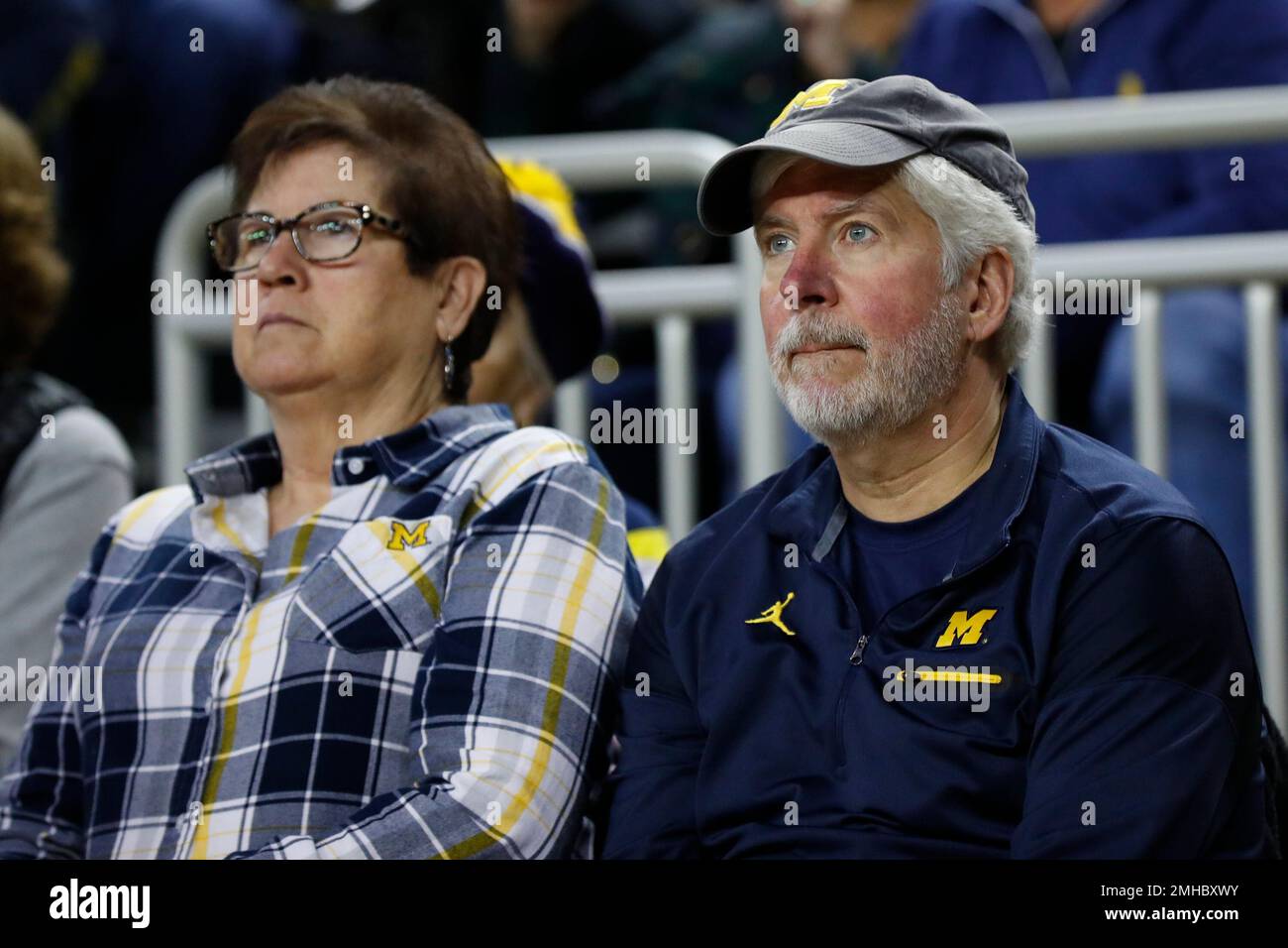 Former Michigan Gov. Rick Snyder and his wife Sue watch an NCAA college ... Former Michigan Gov. Rick Snyder and his wife Sue watch an NCAA college ...