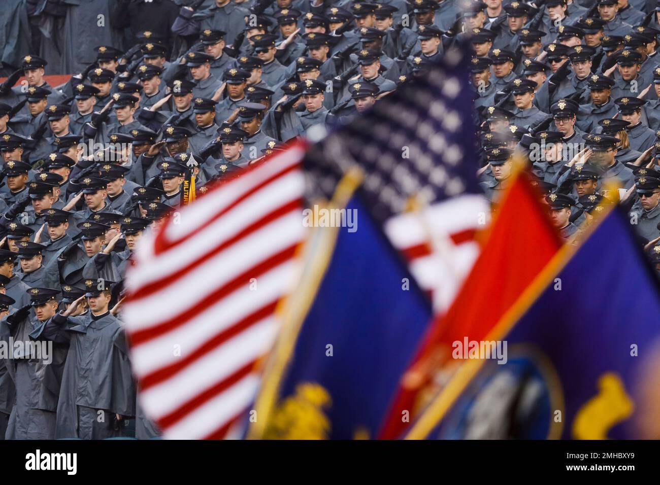 Army cadets salute ahead of an NCAA college football game against Navy ...