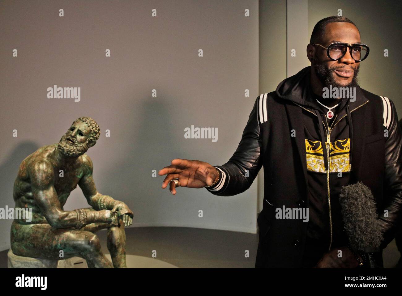 Heavyweight champion Deontay Wilder poses with bronze statue Boxer at ...