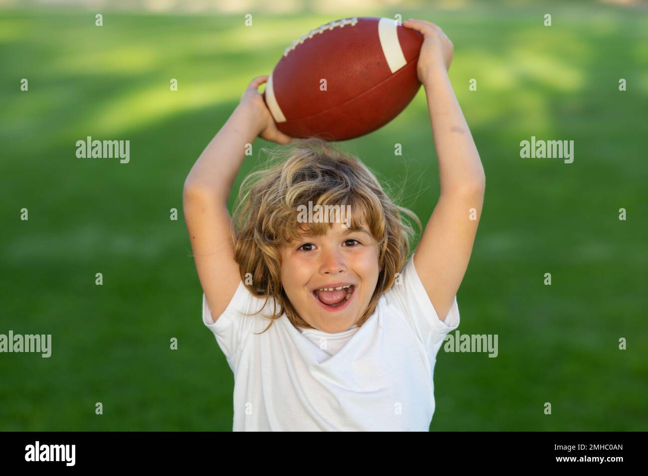 American style football. American football. Child ready to throw a ...