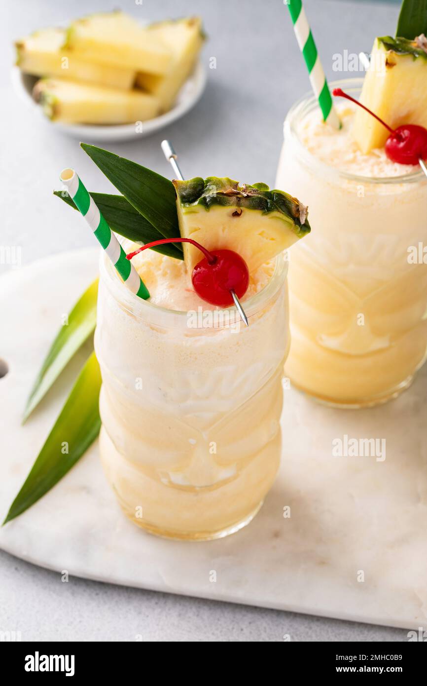 Tropical pina colada cocktail or mocktail in a tiki glass Stock Photo ...