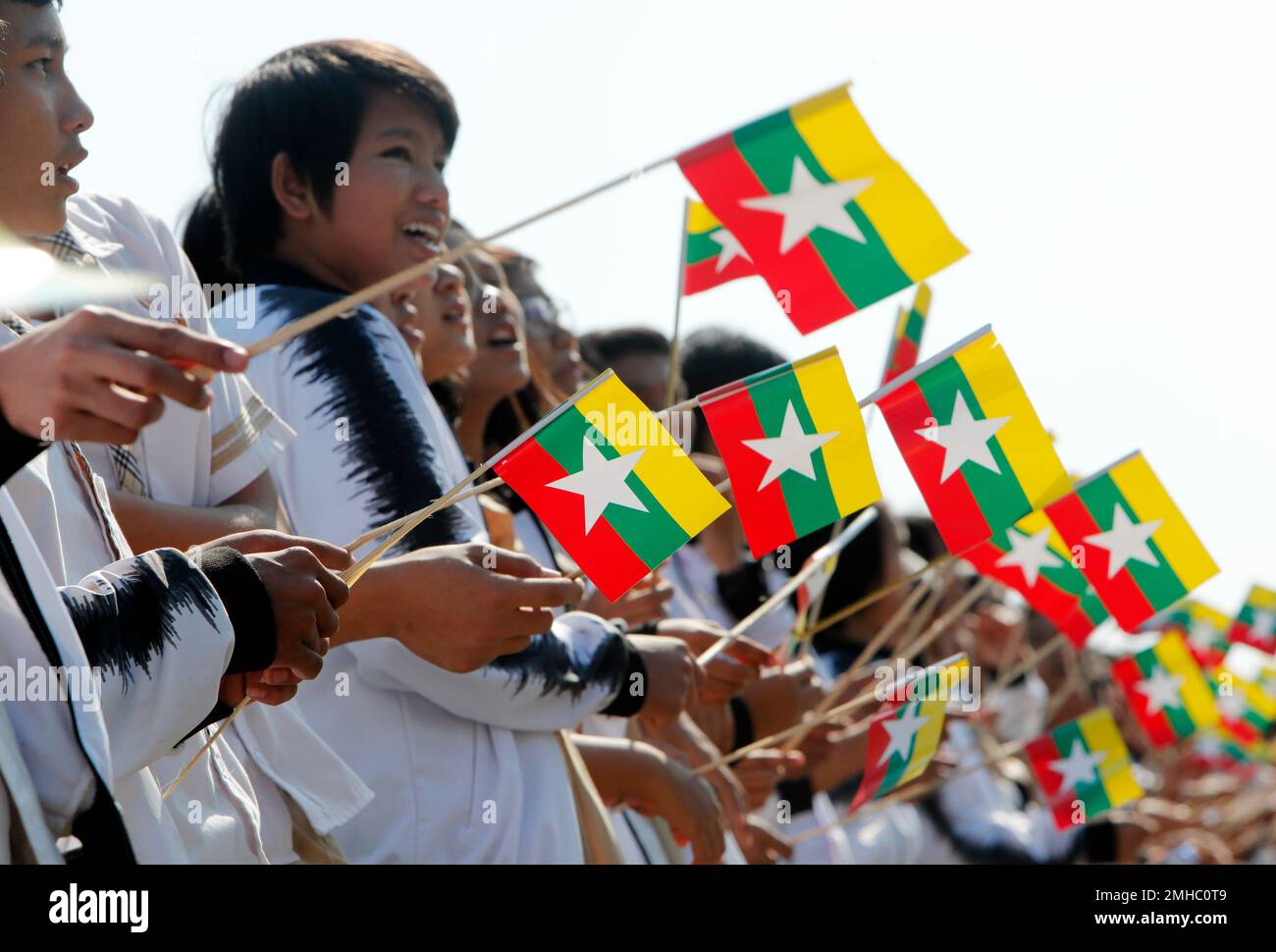 Myanmar Leader Aung San Suu Kyi is welcomed by her supporters waving ...