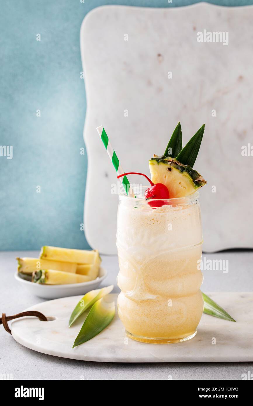 Tropical pina colada cocktail or mocktail in a tiki glass Stock Photo ...