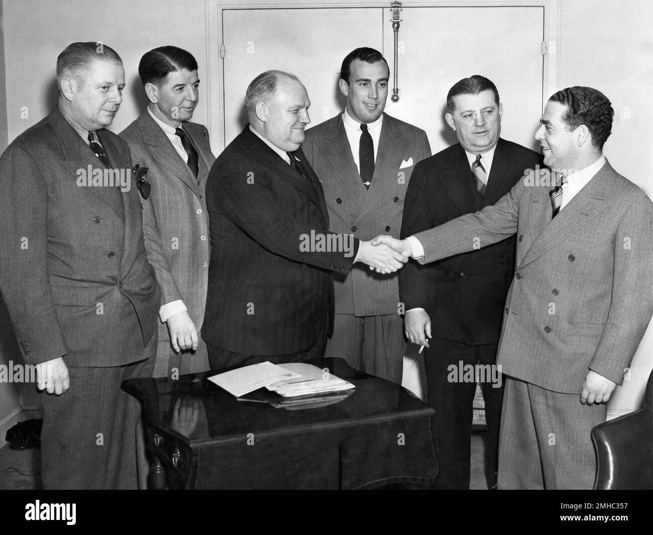 Fred L. Mandel, right, of Chicago is congratulated in New York by ...