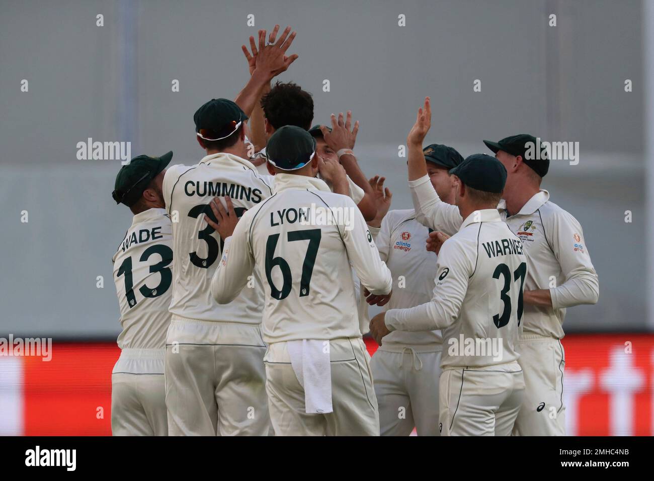 Australian players celebrate after New Zealand's Tom Latham is ...
