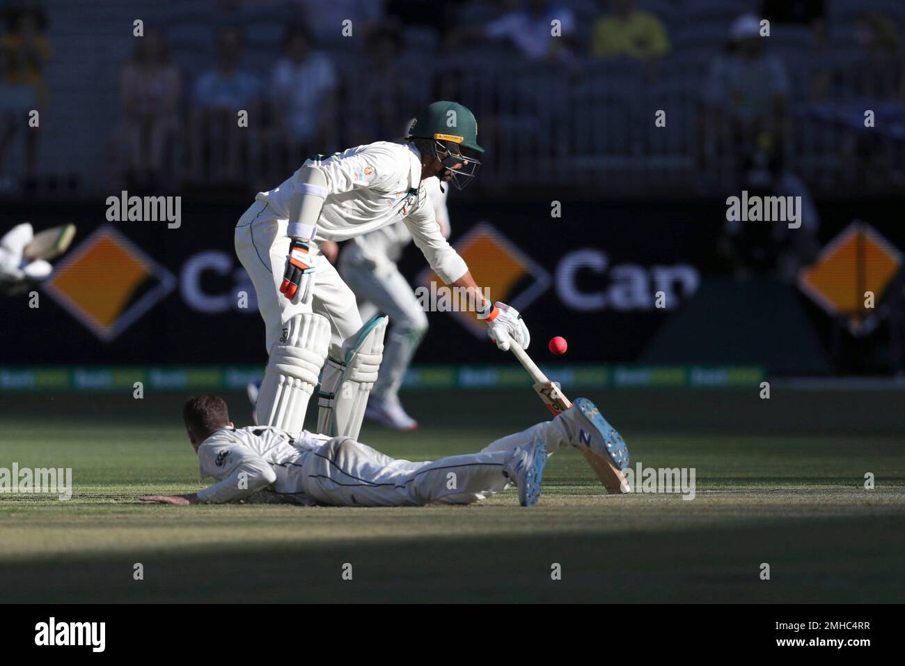 Australia's Mitchell Starc, left, reaches for the crease as New Zealand ...