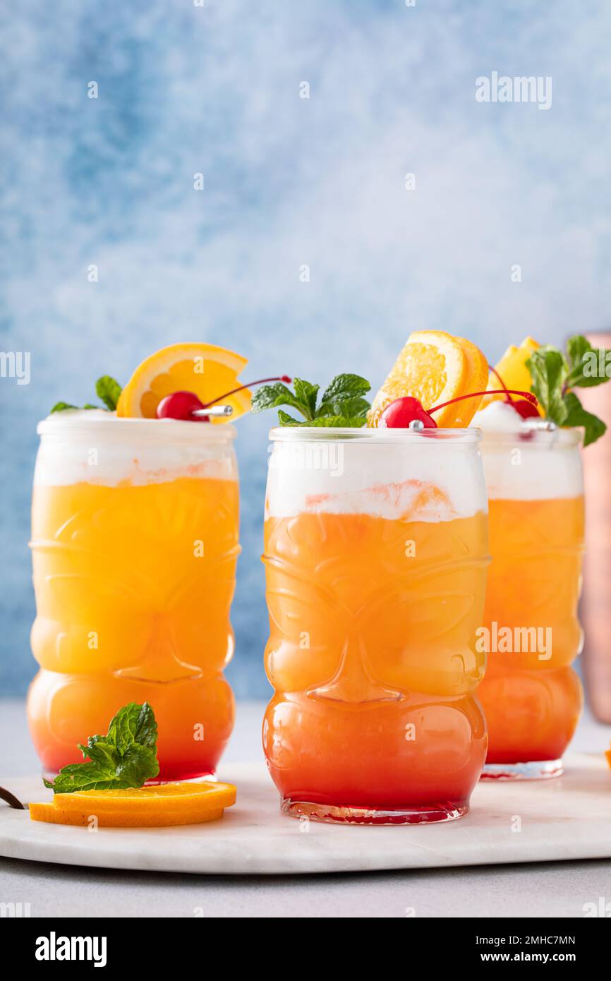 Zombie tropical cocktail with rum in tiki glasses Stock Photo - Alamy