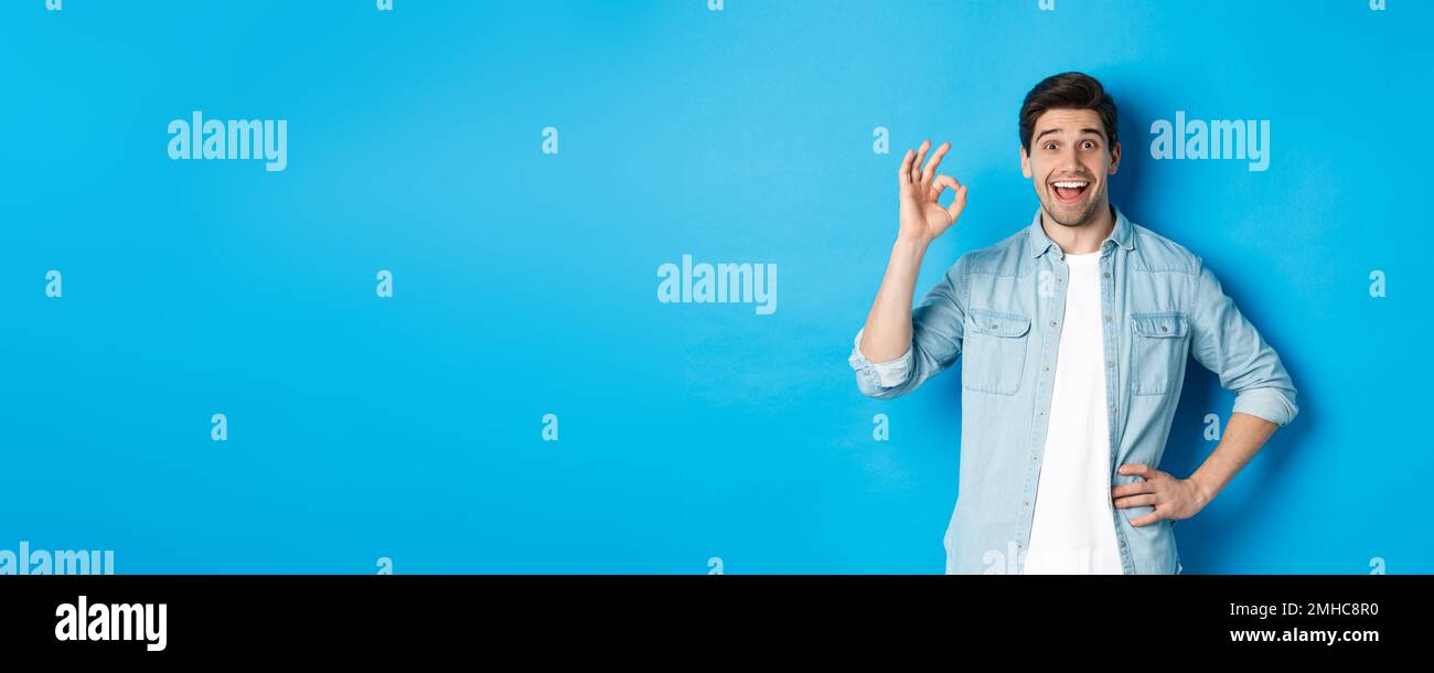 Smiling happy man showing ok sign and looking pleased, approving ...