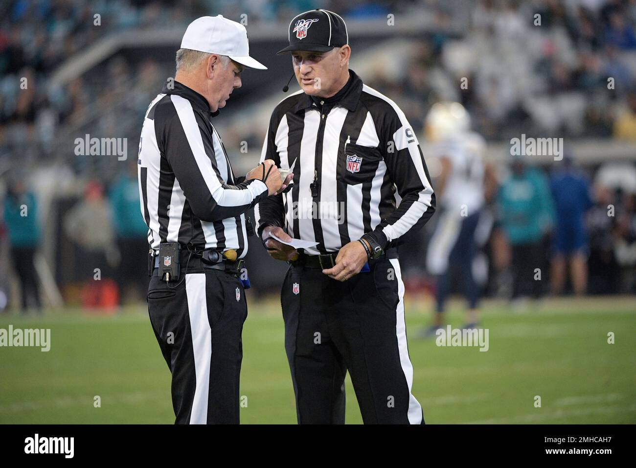 Referee Bill Vinovich, left, and line judge Mark Perlman (9) talk on ...