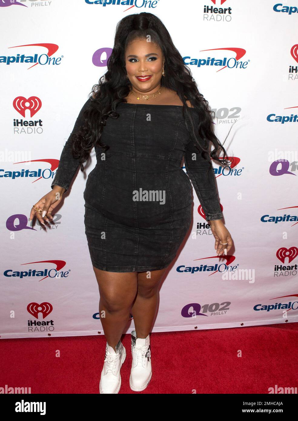 Lizzo poses for photographers backstage during Q102's iHeartRadio ...