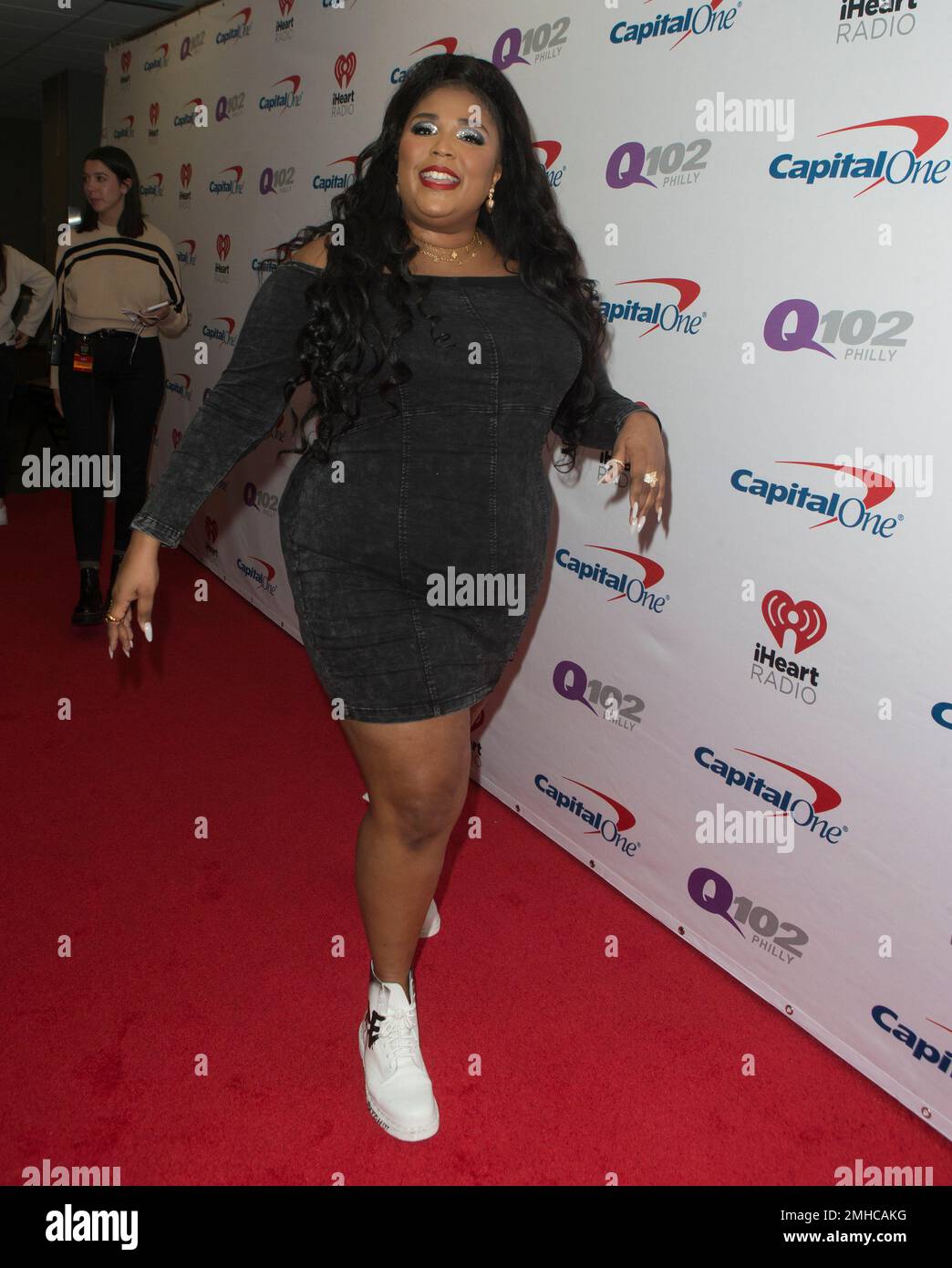 Lizzo poses for photographers backstage during Q102's iHeartRadio ...