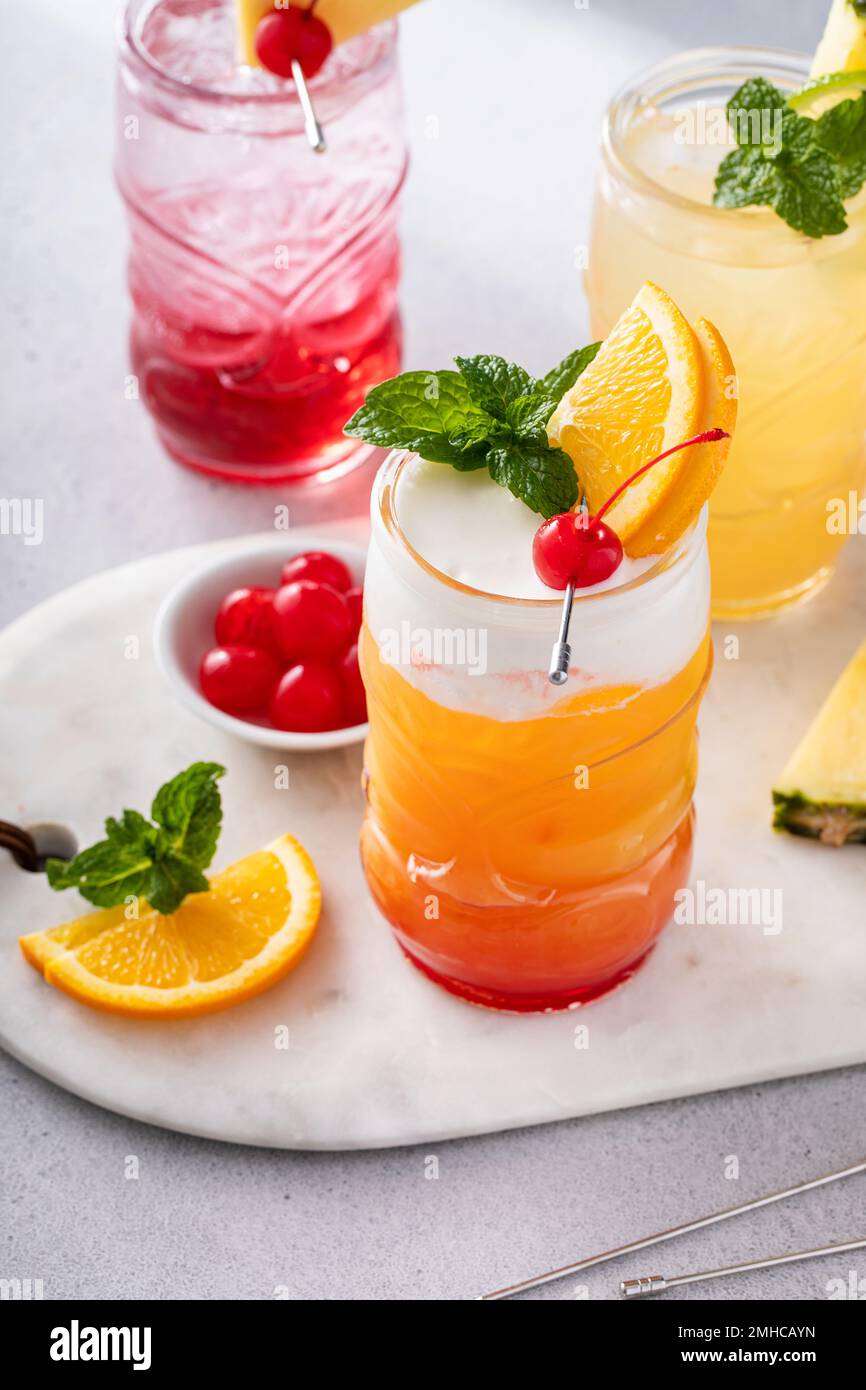 Zombie tropical cocktail with rum in tiki glasses Stock Photo - Alamy